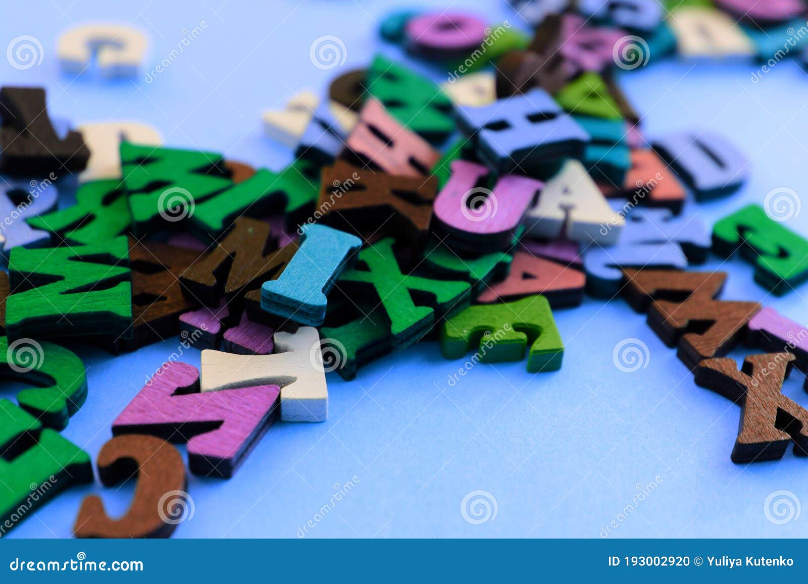 The Letters of the Alphabet are Scattered Randomly on a Blue Background ...