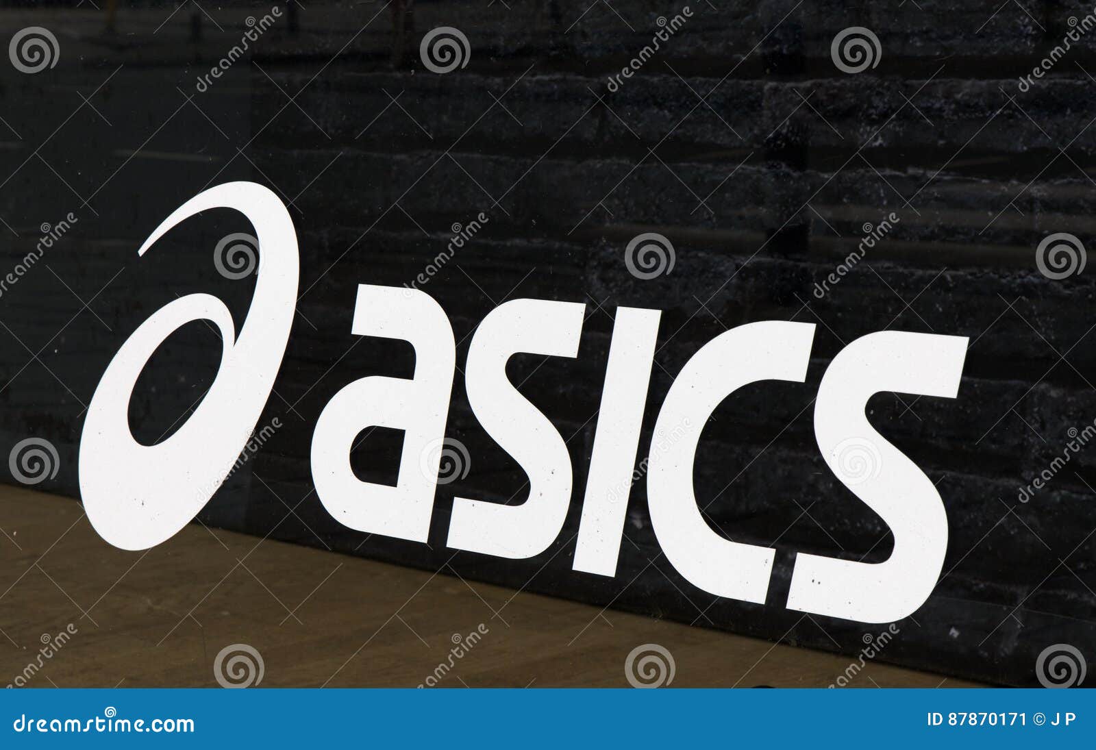 Letters asics on a wall i editorial photo. Image of style - 87870171