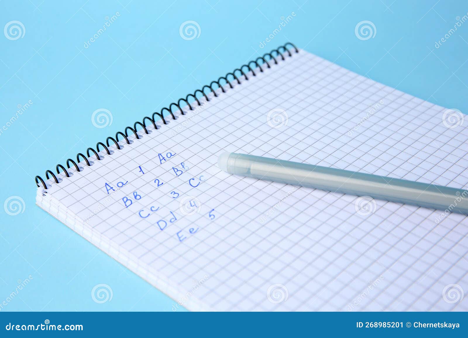 Letters and Numbers Written in Notepad with Erasable Pen on Light Blue ...