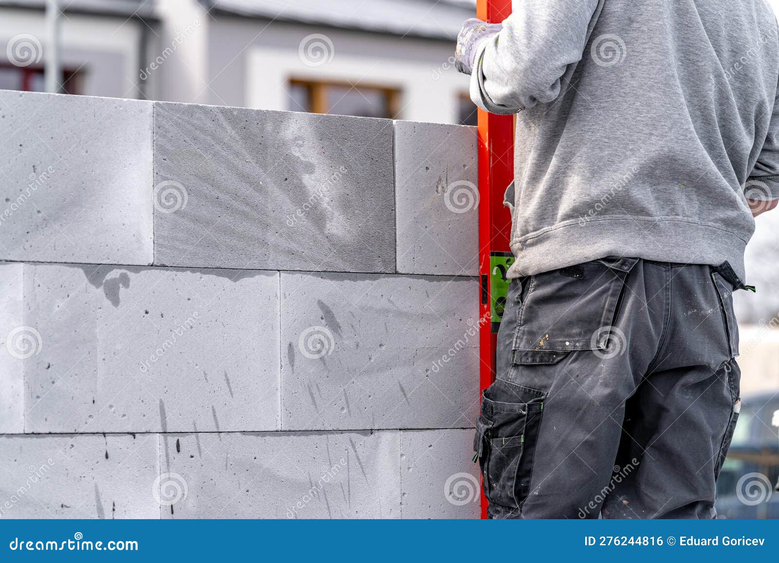 Bricklayer Leveling Bricks with the Help of a Spirit Level during the ...