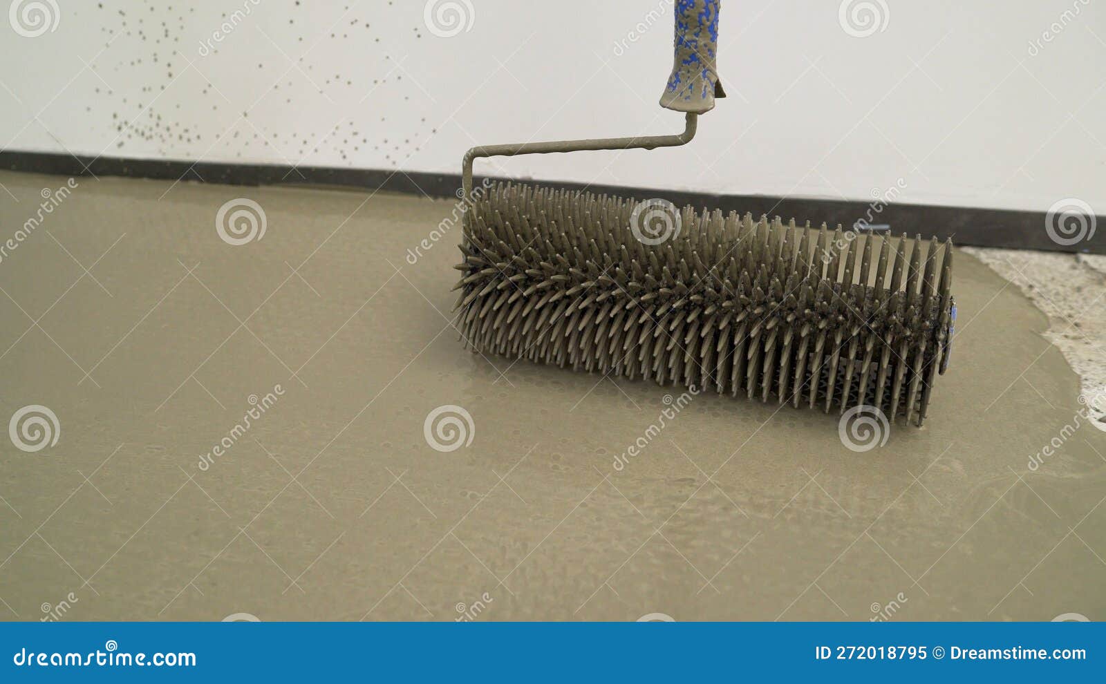 Leveling the Floor Using Spiked Roller. Construction Worker Mixes ...