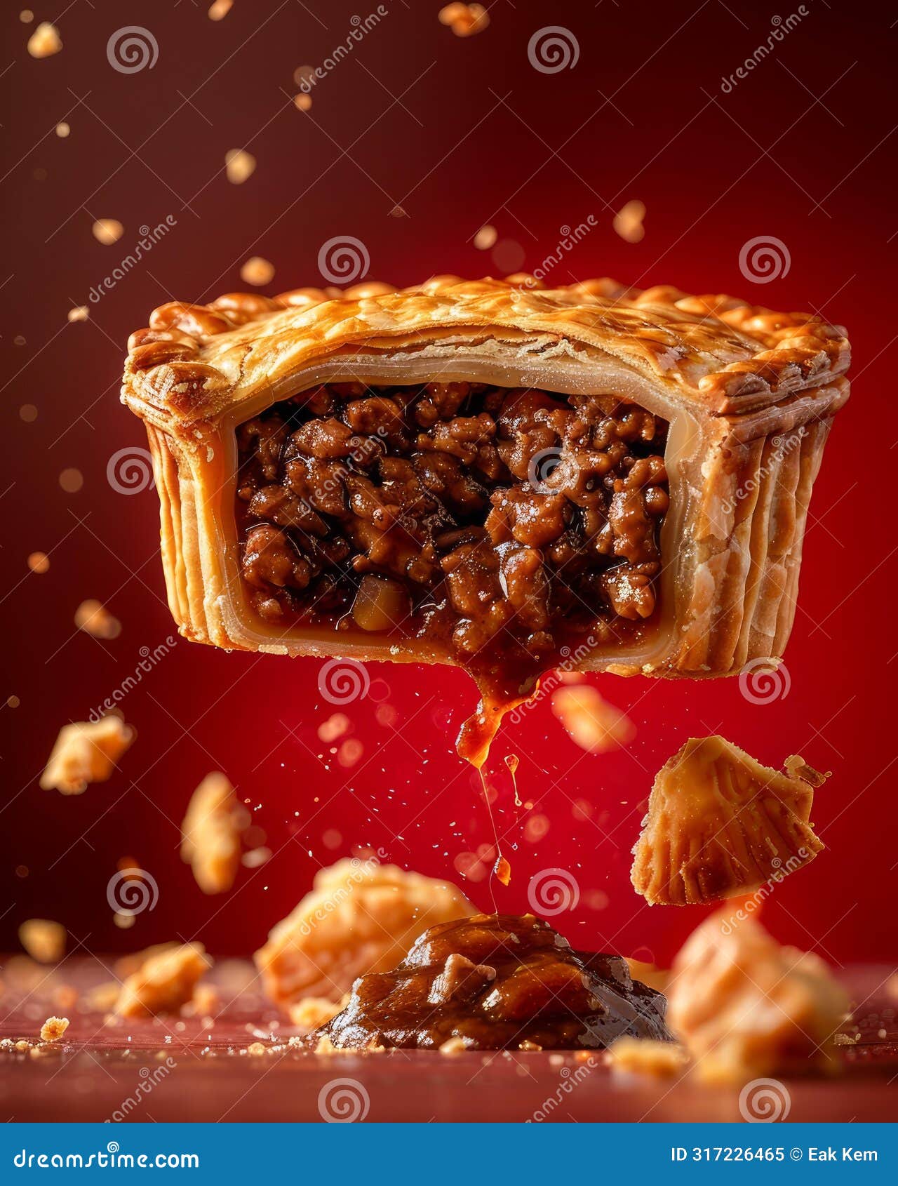 Levitating Meat Pie Cut in Half with Filling and Crust Pieces Falling ...
