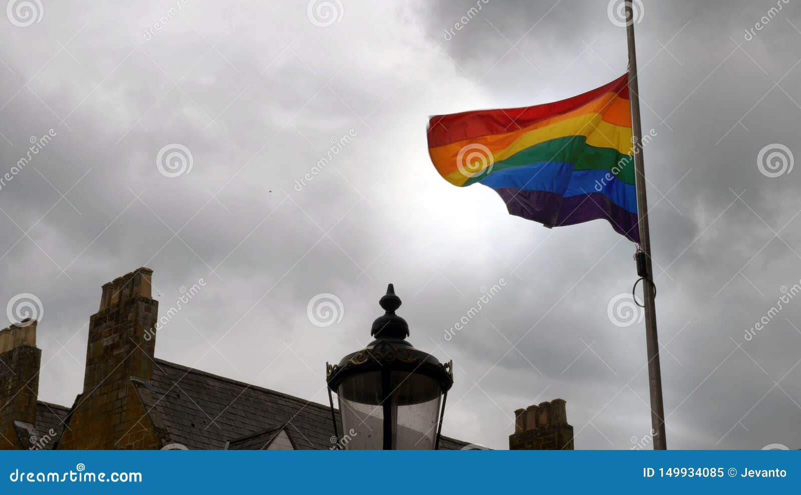 Lgbt Rainbow Pride Flag Waving At Wind On Cloudy British Sky Background
