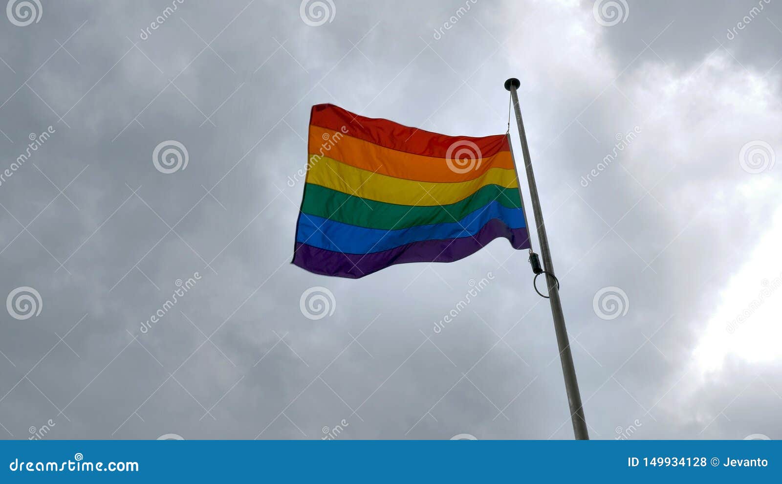 Lgbt Rainbow Pride Flag Waving At Wind On Cloudy British Sky Background