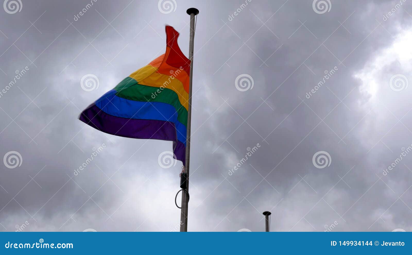 Lgbt Rainbow Pride Flag Waving At Wind On Cloudy British Sky Background
