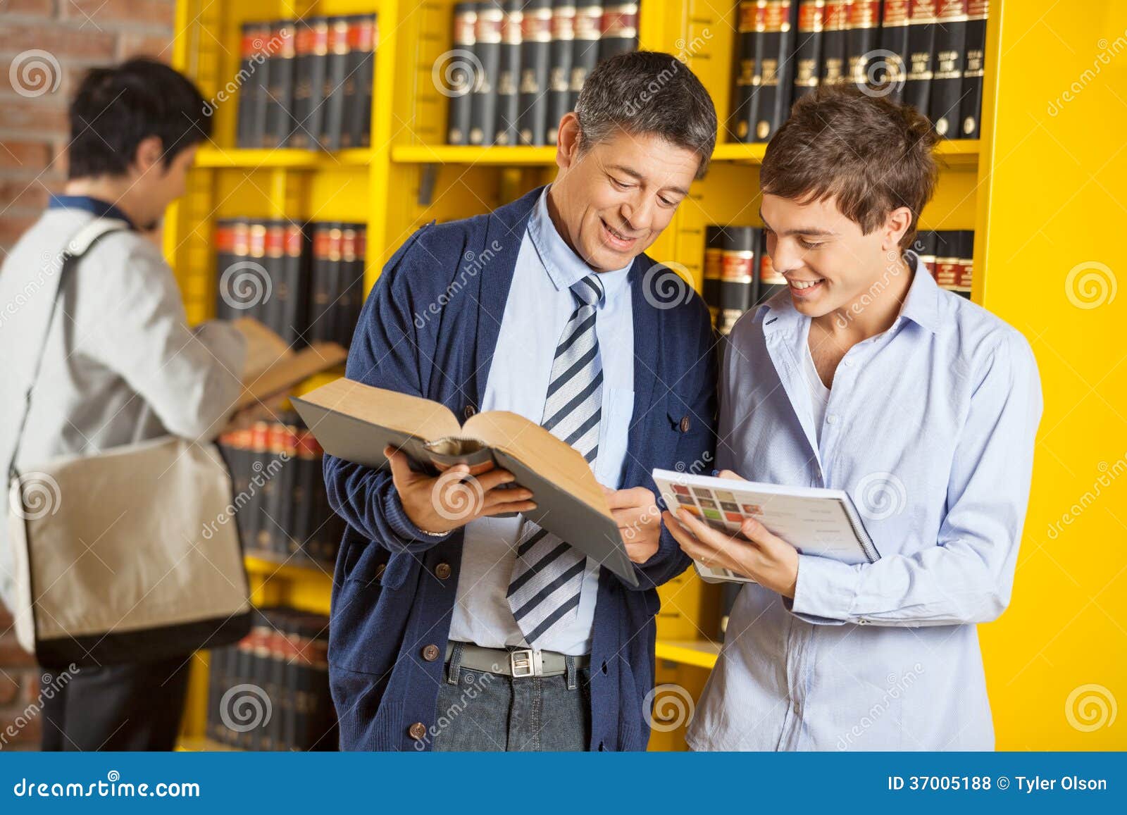 Librarian Assisting Student in University Library Stock Photo - Image ...