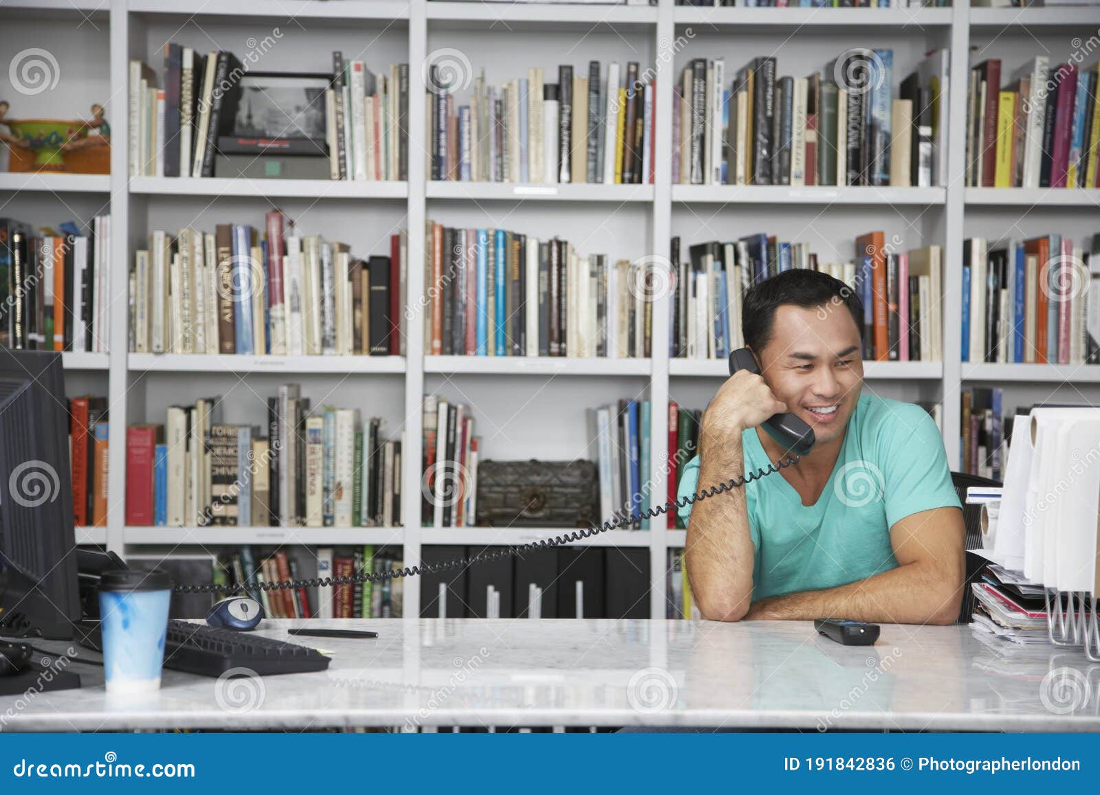 Librarian Sitting and Talking on Telephone Stock Photo - Image of ...