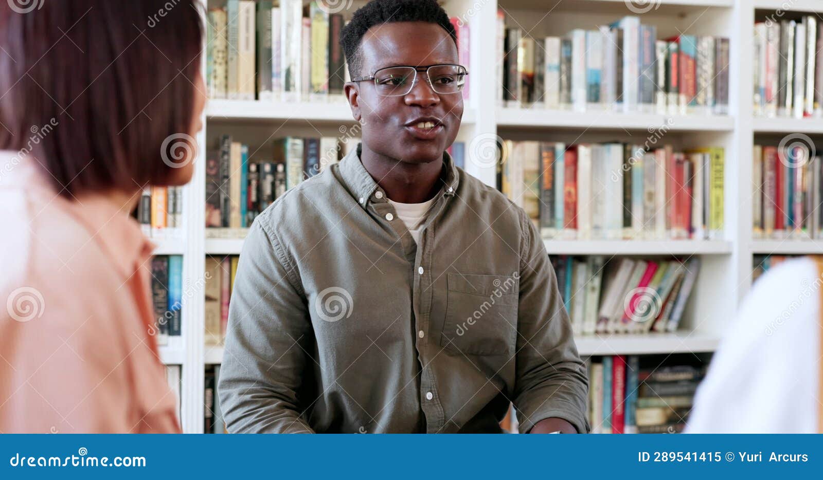 Library, Study Group and Black Man Talking in University, Education ...