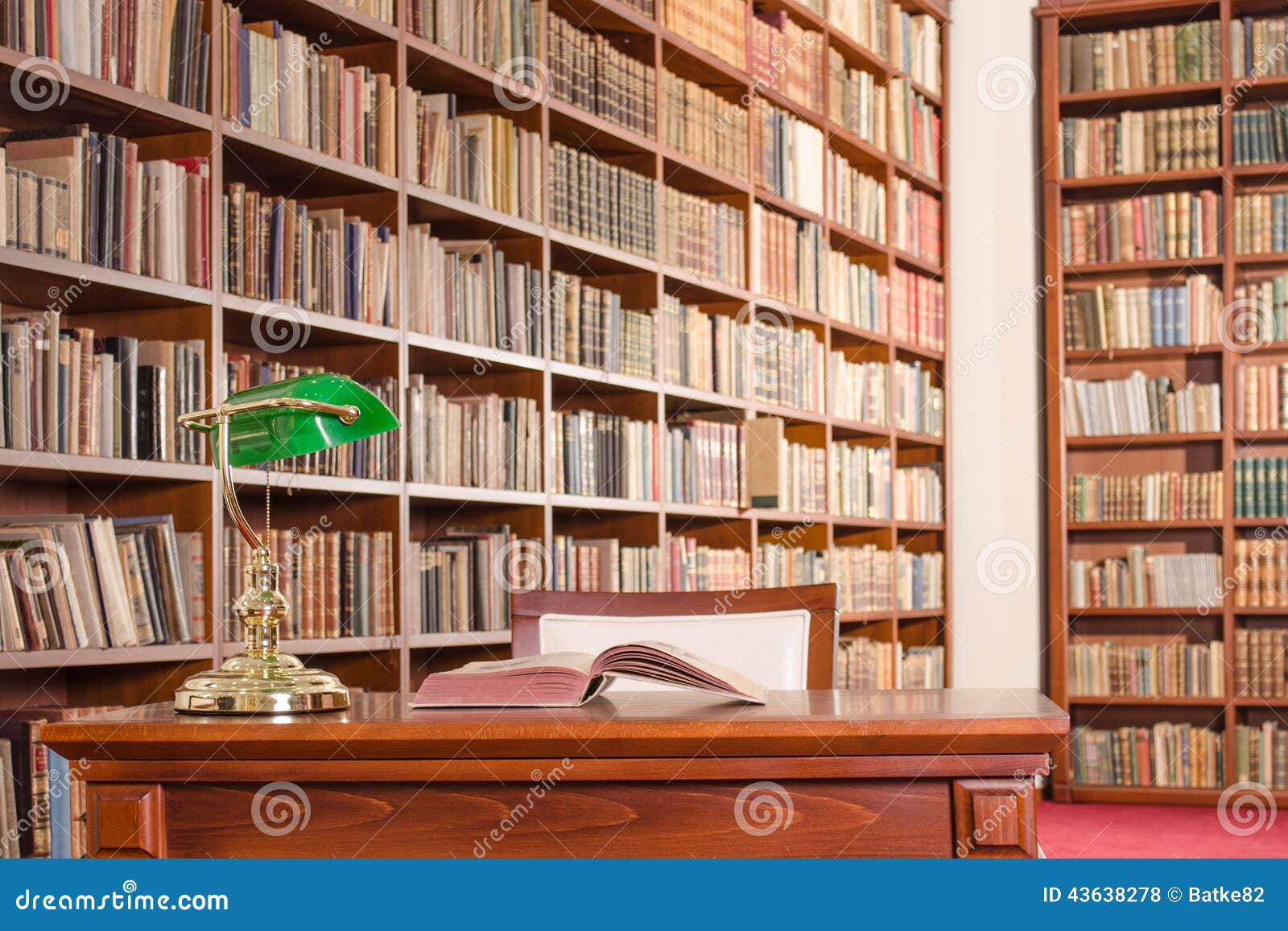Library Table with Bookshelf in the Background Stock Photo - Image of ...