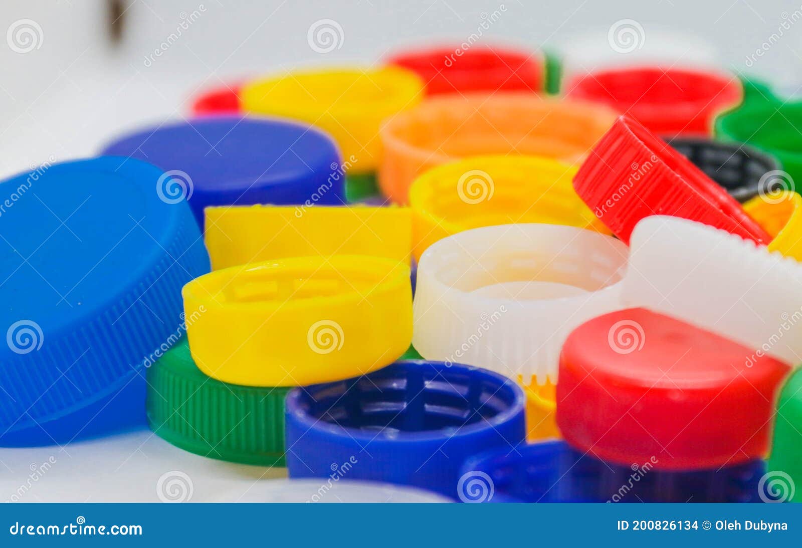 Plastic Lids of Different Colors on a White Background Stock Photo ...