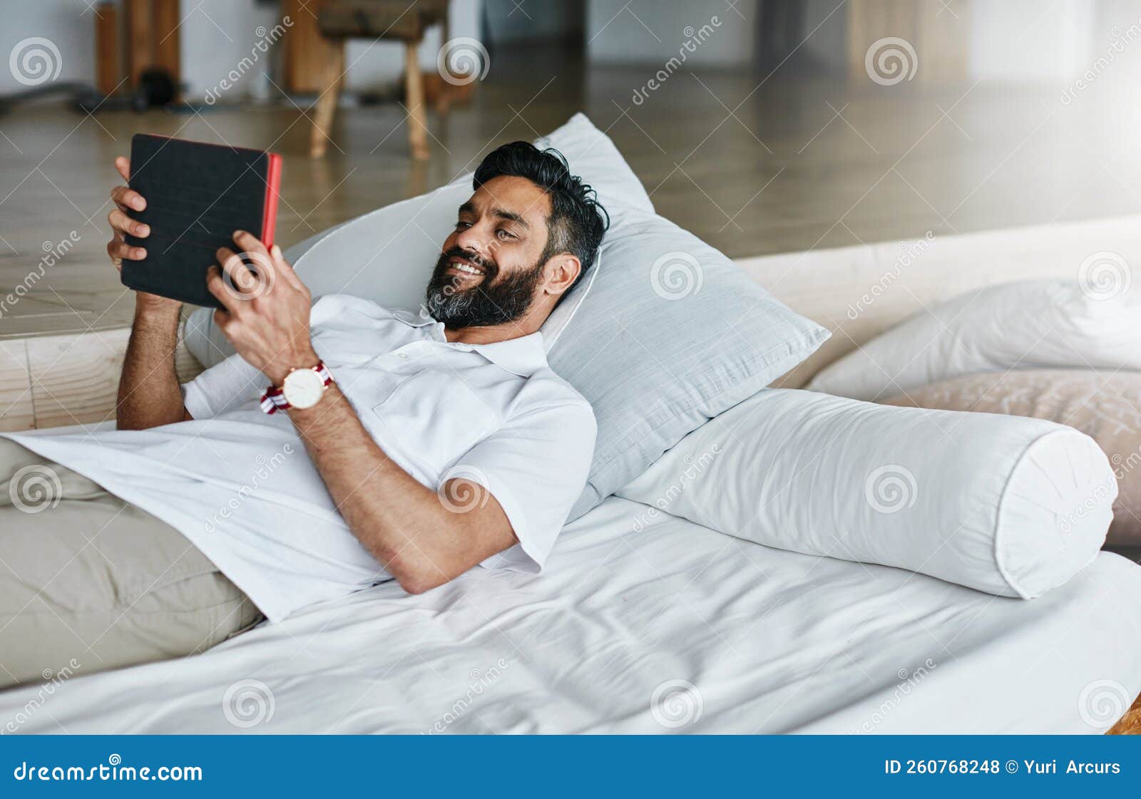 The Life of a Bachelor. a Easygoing Bachelor Using His Tablet while ...