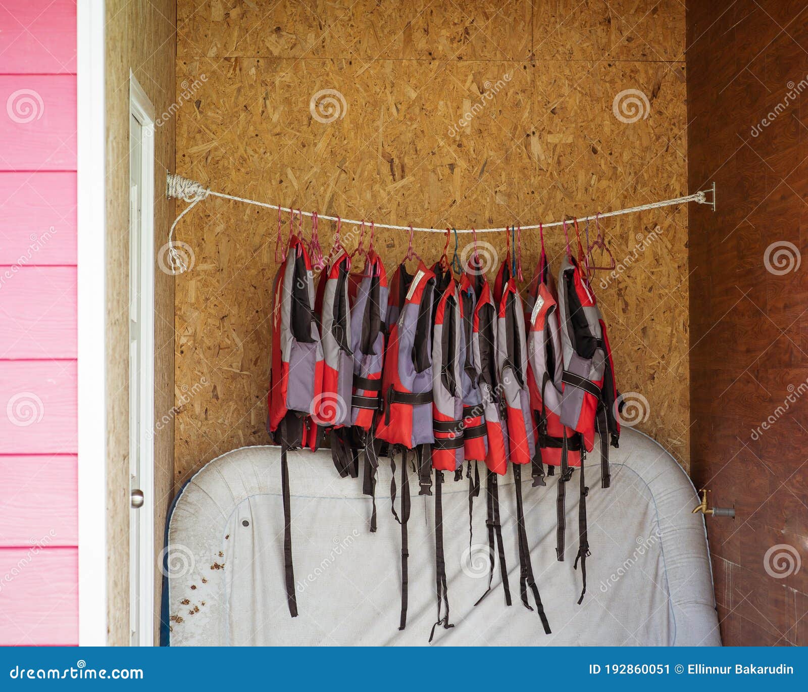 The Life Jacket Hanging on a Rope on a Wooden Wall Stock Image - Image ...