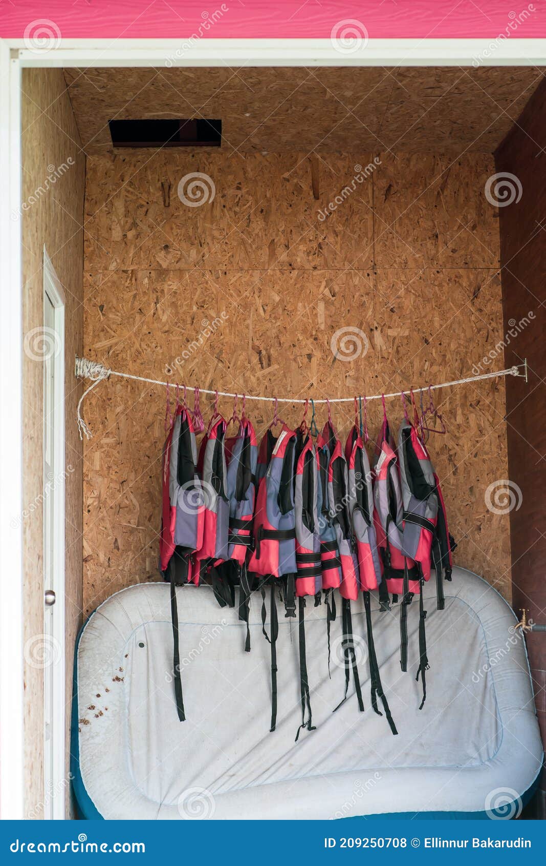The Life Jacket Hanging on a Rope on a Wooden Wall Stock Photo - Image ...