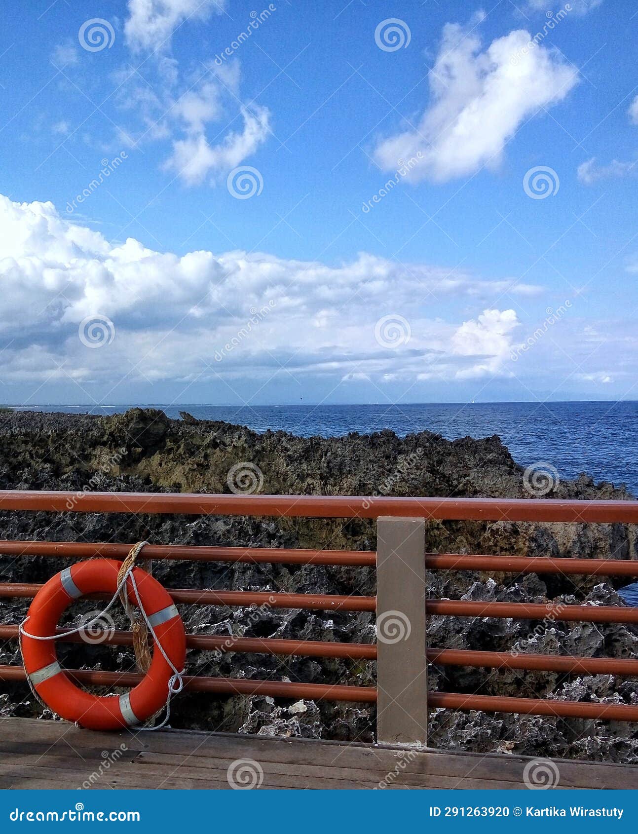 Life Preserver on Fence on Beach with Sky Background Stock Photo ...