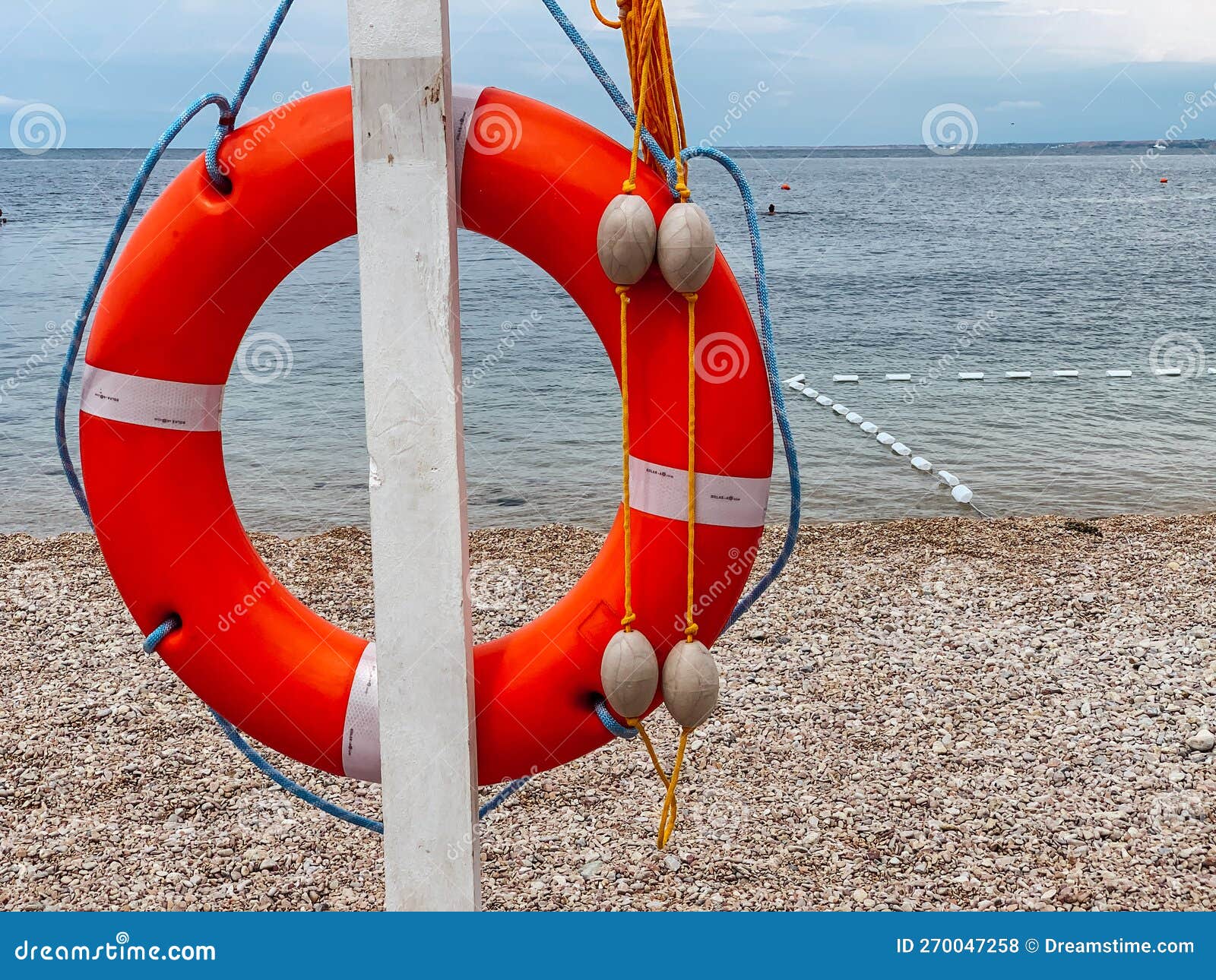 Life Ring on the Seashore by the Water Stock Photo - Image of equipment ...