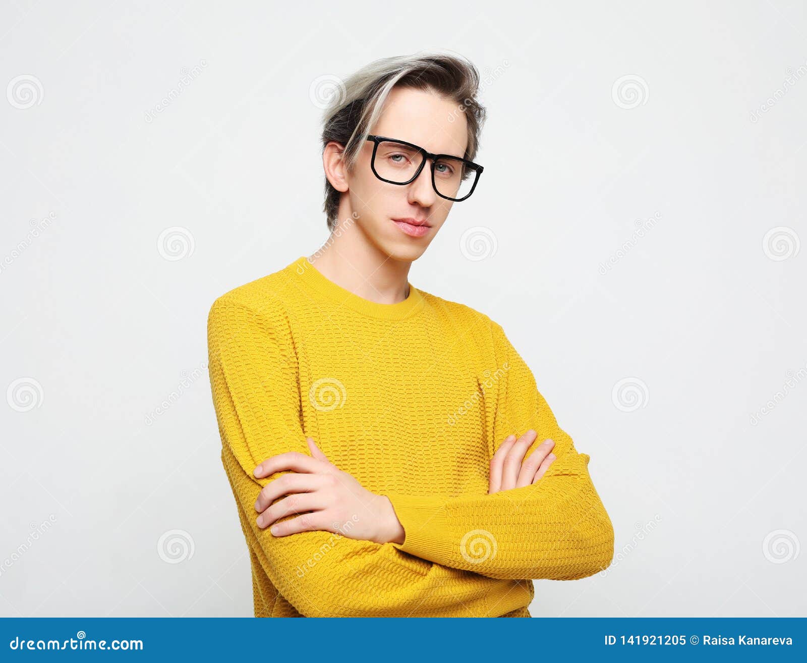 Portrait Of A Smart Young Man Wearing Eyeglasses Standing Against White