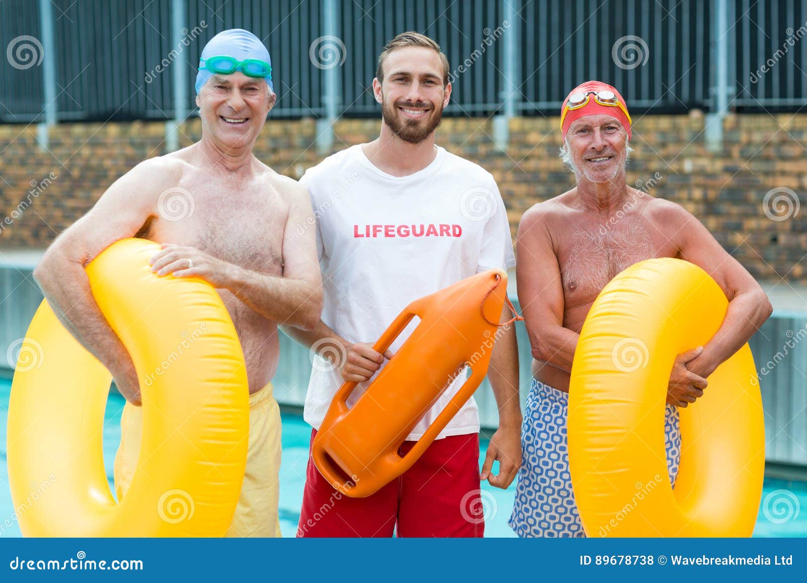 Lifeguard with Senior Swimmers at Poolside Stock Photo - Image of ...