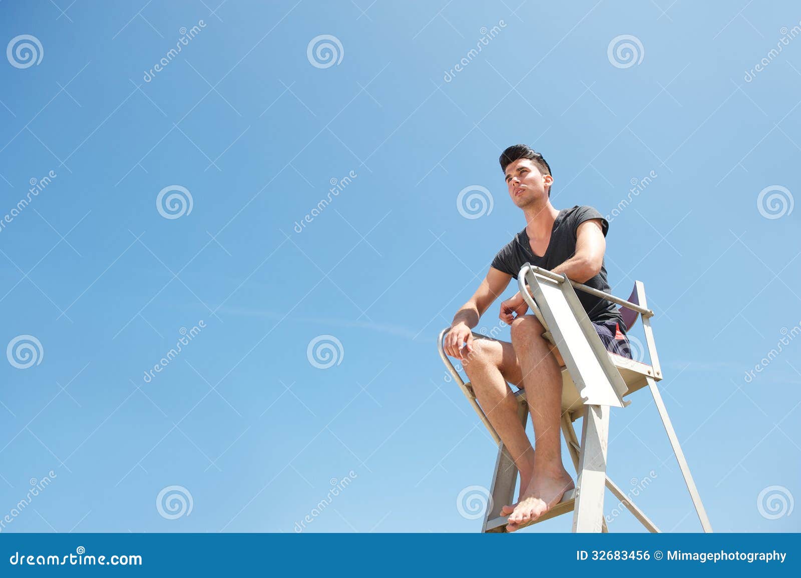 Lifeguard Sitting on Elevated Chair Stock Photo - Image of elevated ...