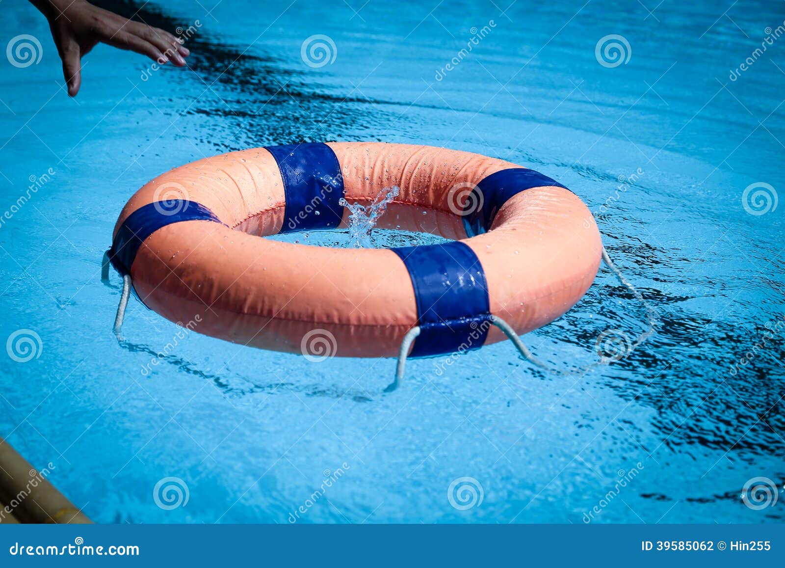 Lifeguard Throw Life Ring Floating To Someone In Swiming Pool Stock