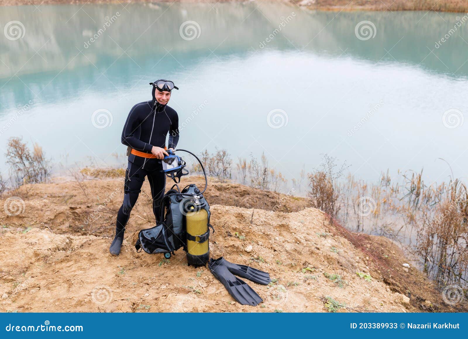 A Lifeguard in a Wetsuit is Preparing To Dive into the Pond. Search at ...