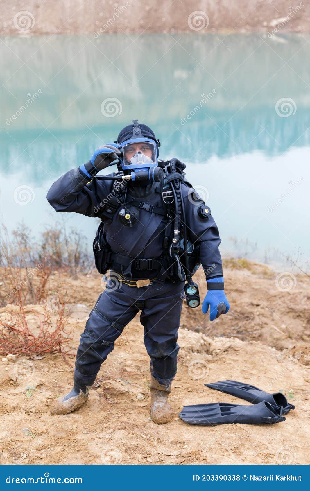 A Lifeguard in a Wetsuit is Preparing To Dive into the Pond. Search at ...