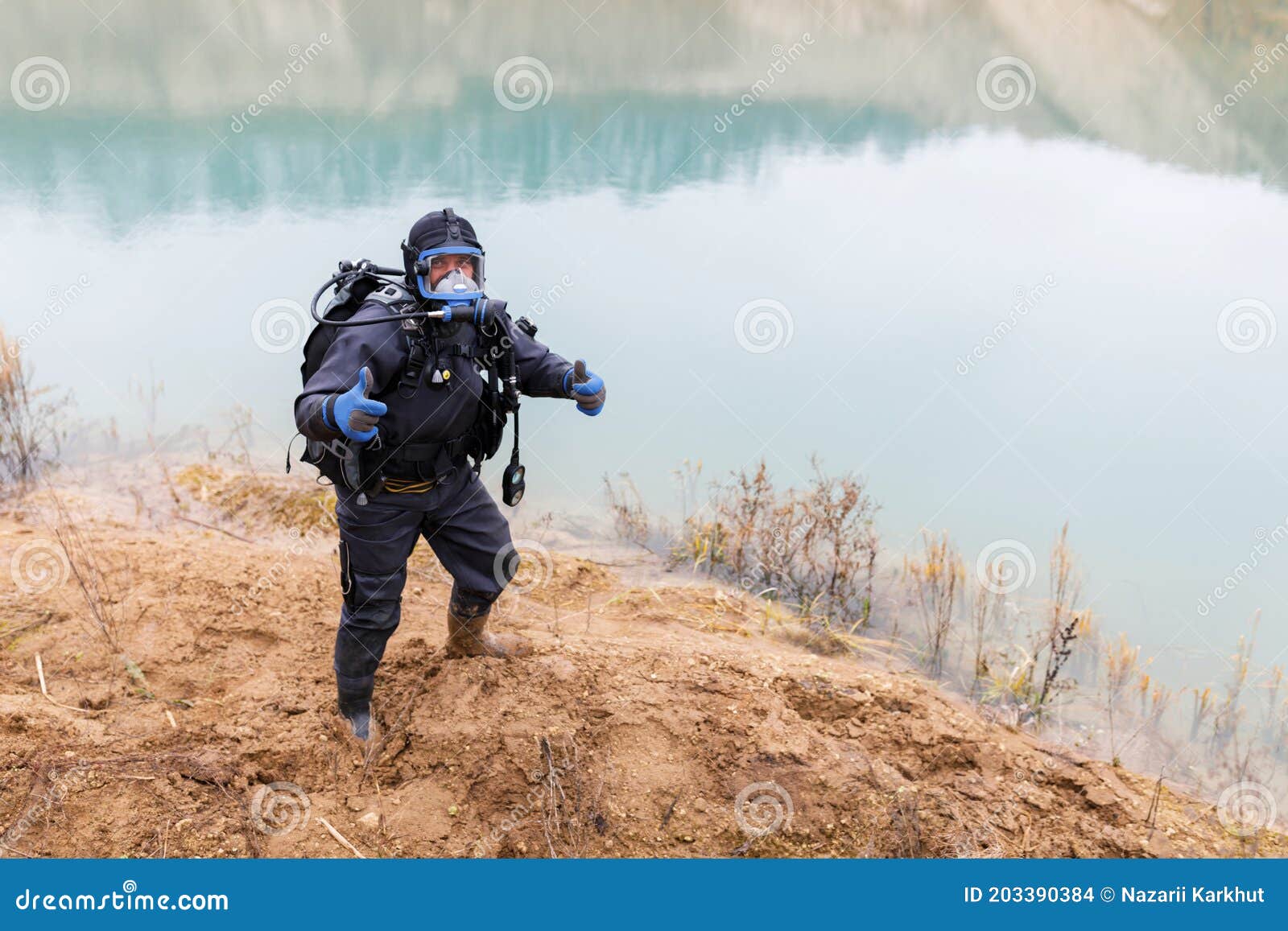 A Lifeguard in a Wetsuit is Preparing To Dive into the Pond. Search at ...