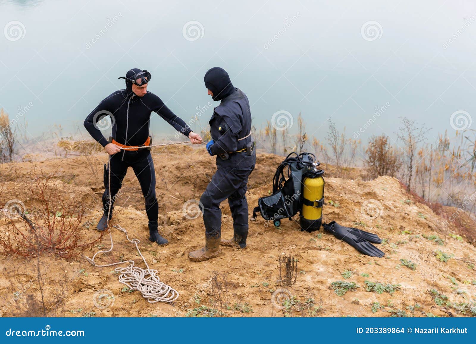 Lifeguard in a Wetsuit To Work Underwater. Search at the Bottom of the ...