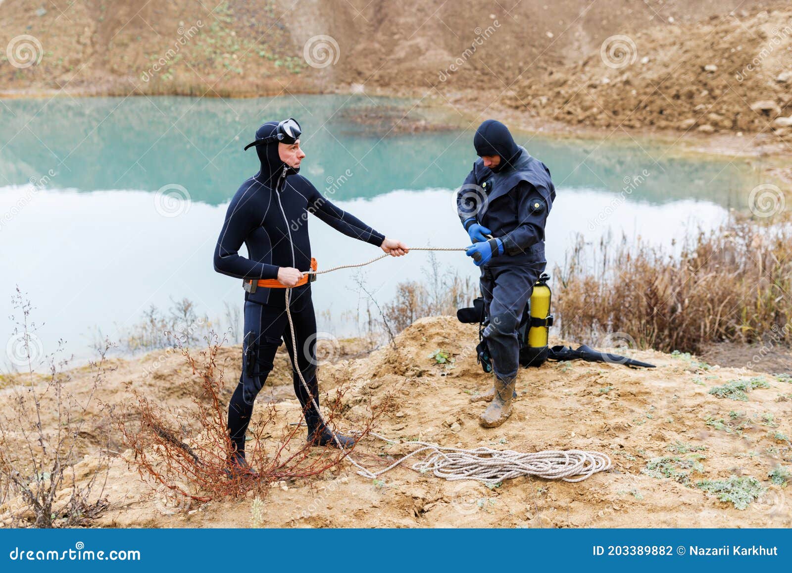 Lifeguard in a Wetsuit To Work Underwater. Search at the Bottom of the ...