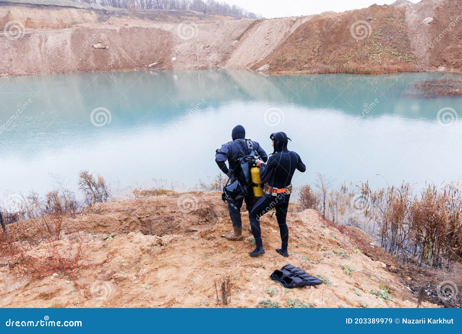 Lifeguard in a Wetsuit To Work Underwater. Search at the Bottom of the ...