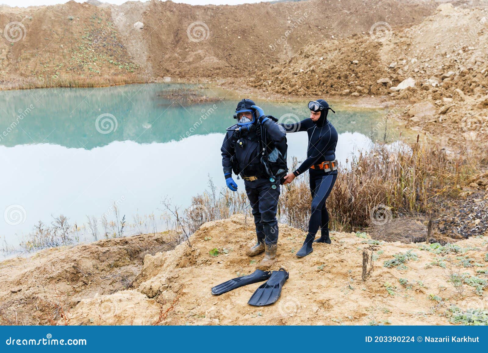 Lifeguard in a Wetsuit To Work Underwater. Search at the Bottom of the ...