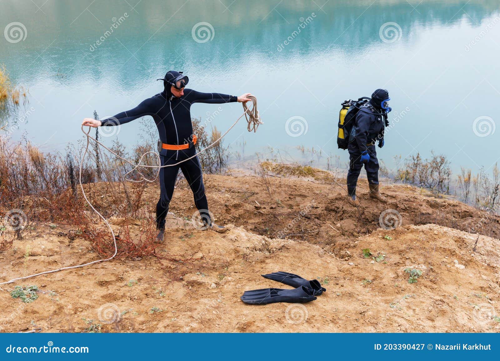 Lifeguard in a Wetsuit To Work Underwater. Search at the Bottom of the ...