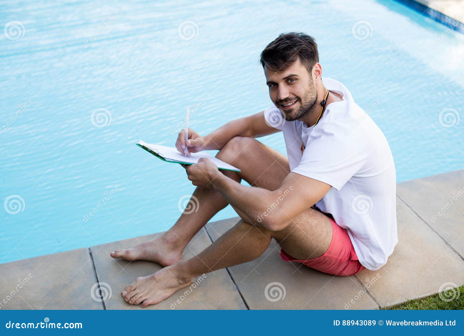Lifeguard Writing on Clipboard at Poolside Stock Image - Image of adult ...