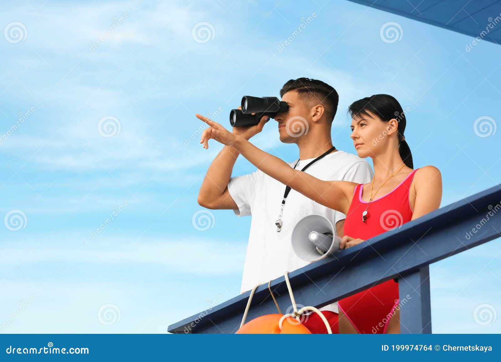 Lifeguards with Megaphone and Binocular on Watch Tower Against Blue Sky ...