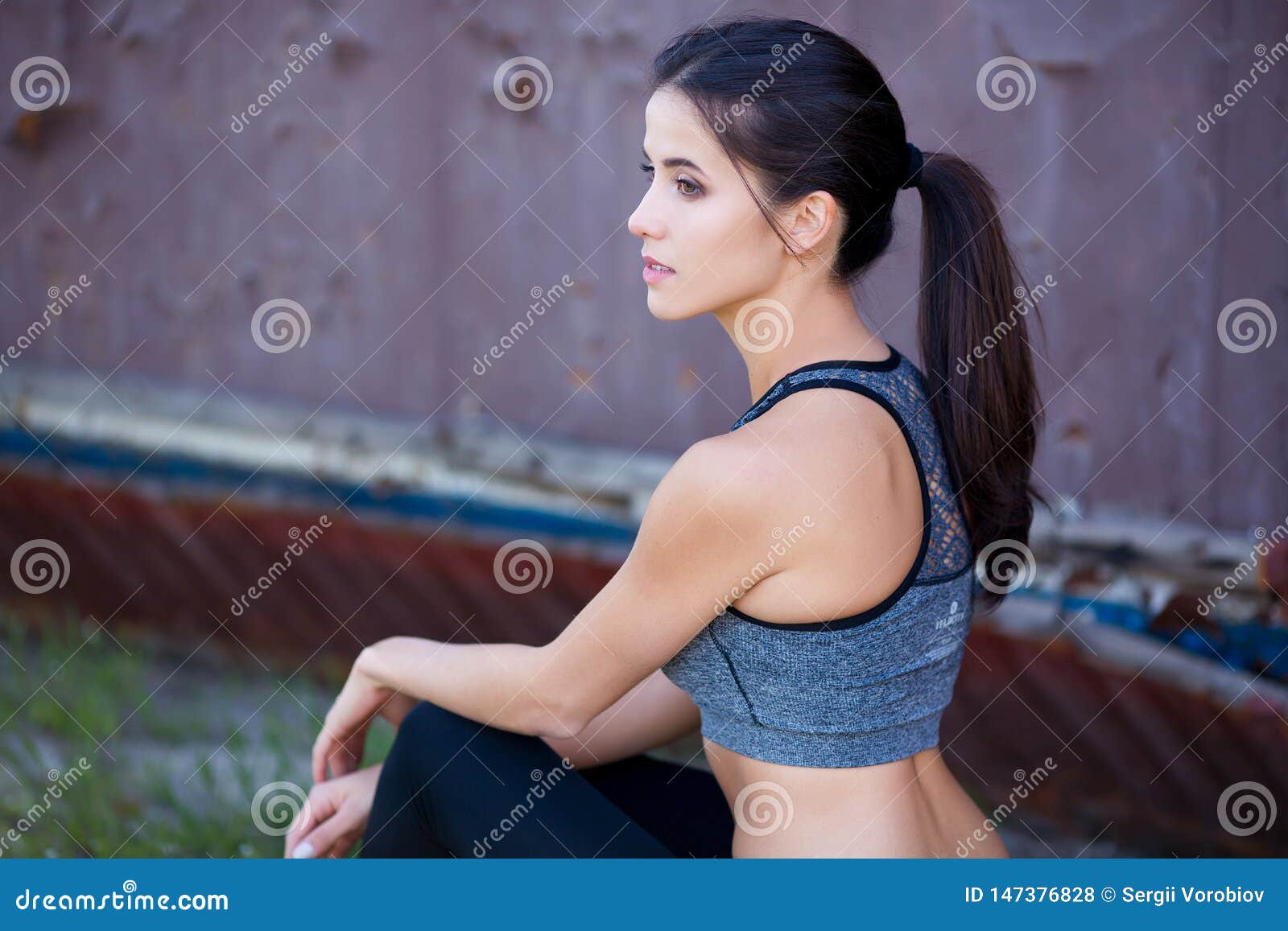 Lifestyle Portrait Of Fitness Pretty Young Woman Wearing Grey Sports