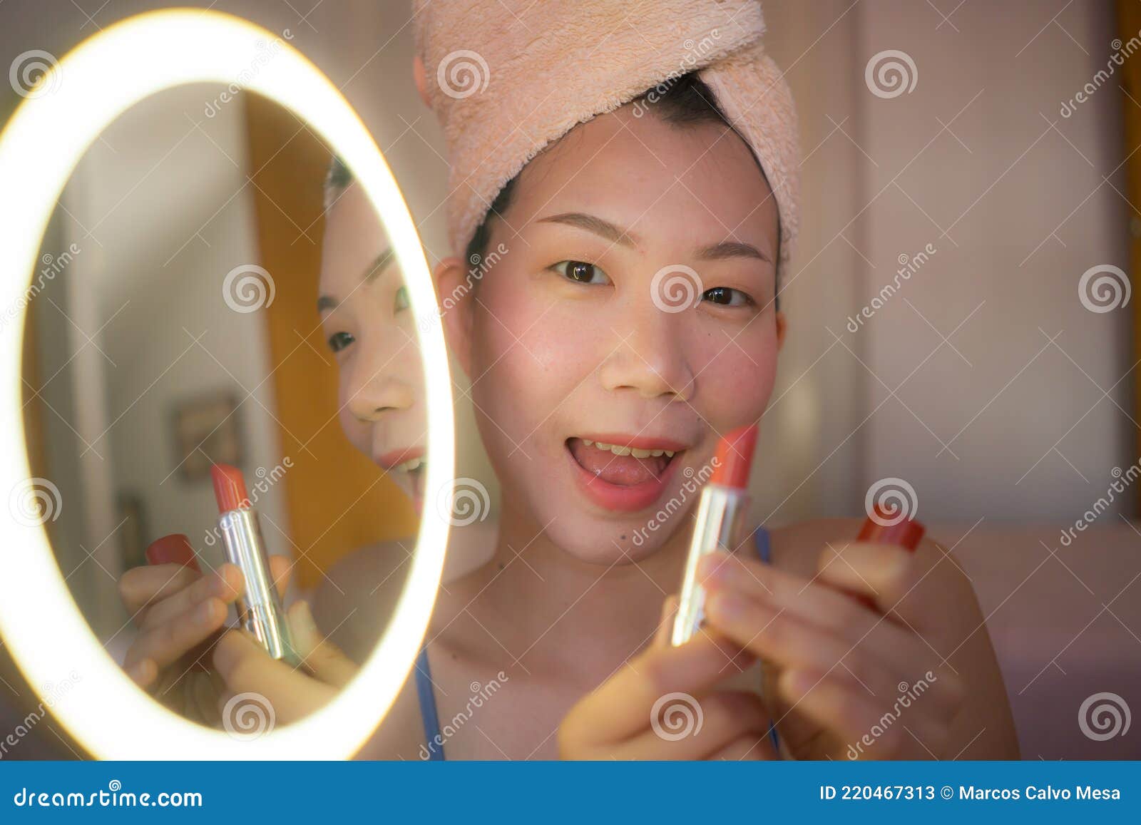 Lifestyle Portrait Of Young Beautiful And Happy Asian Woman Applying