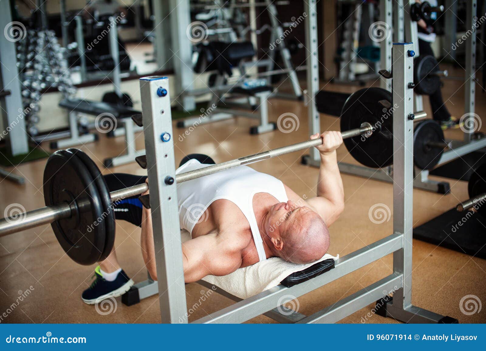 Lifting the bar lying down stock photo. Image of person - 96071914