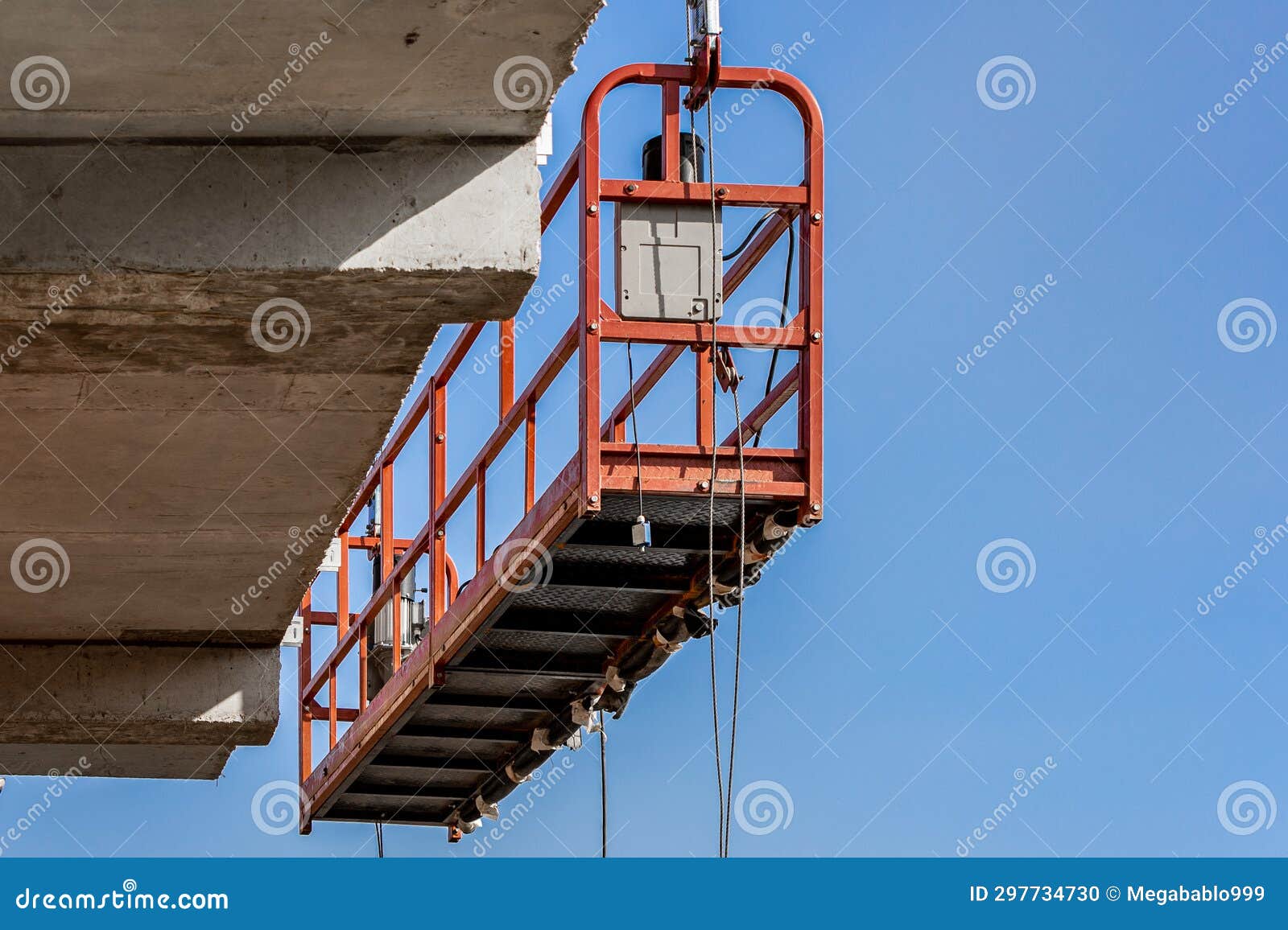 A Lifting Cradle at a Construction Site Hangs on the Monolithic Frame ...