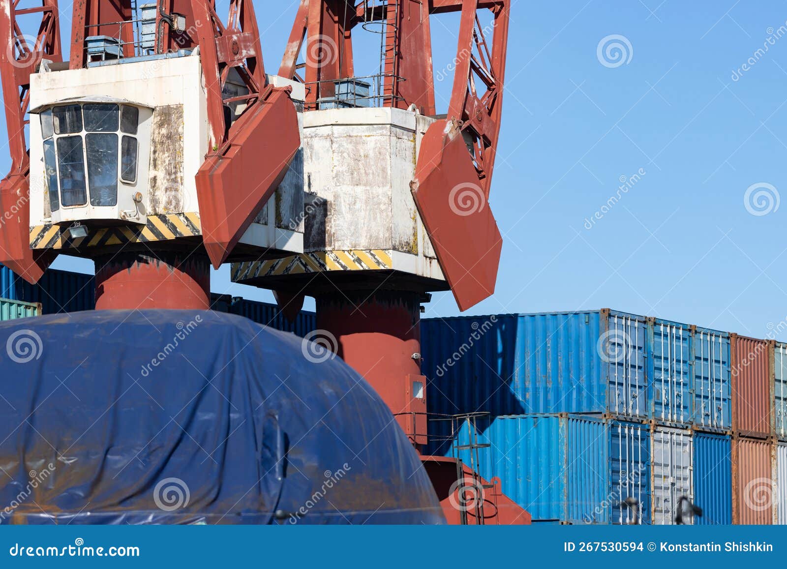 Lifting Cranes and Multi-colored Cargo Containers in the Seaport Stock ...