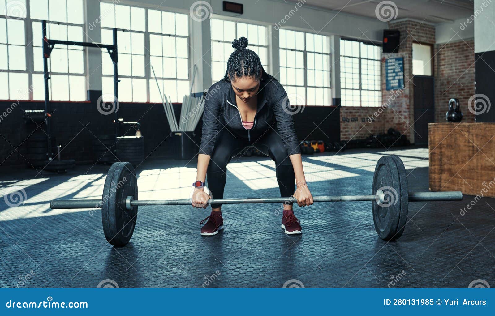 Lifting for Strength. a Young Woman Lifting Weights in a Gym. Stock ...