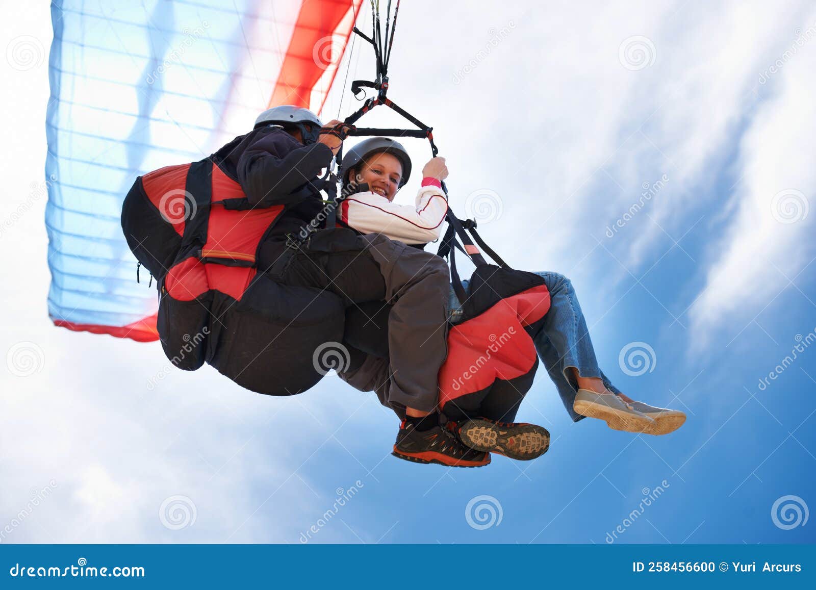 Light As Air. Low Angle View of Two People Doing Tandem Paragliding L ...