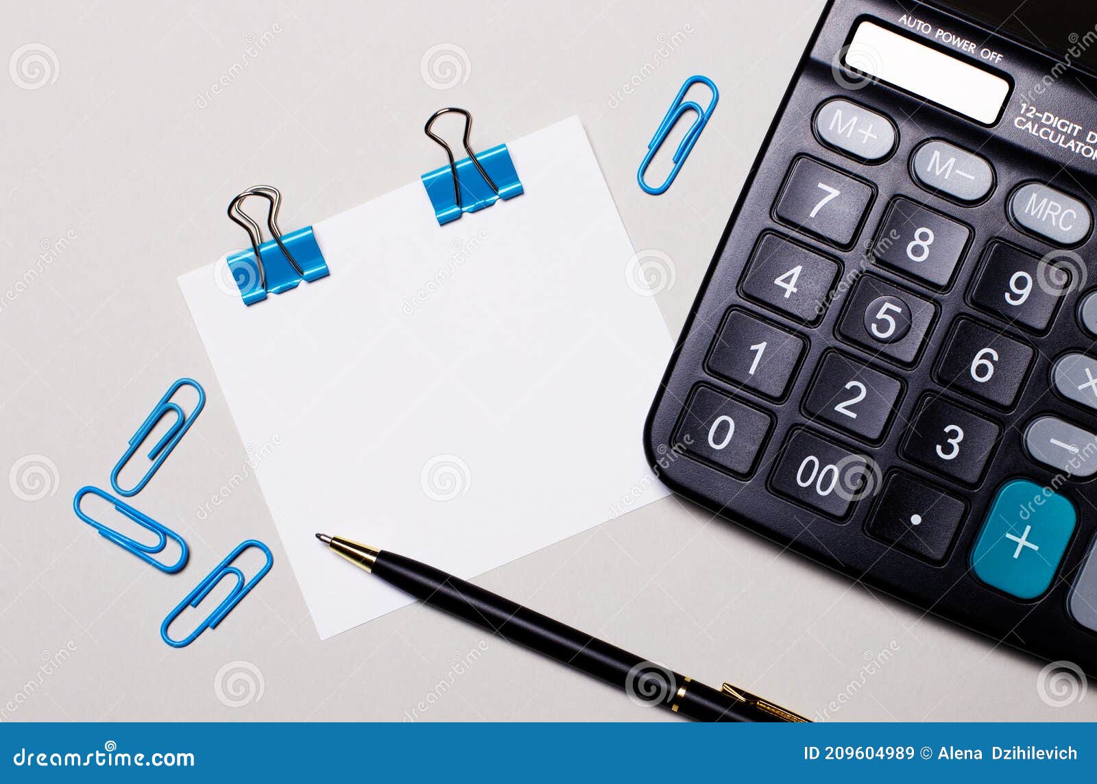 On a Light Background, a Calculator, a Pen, Blue Paper Clips and a ...