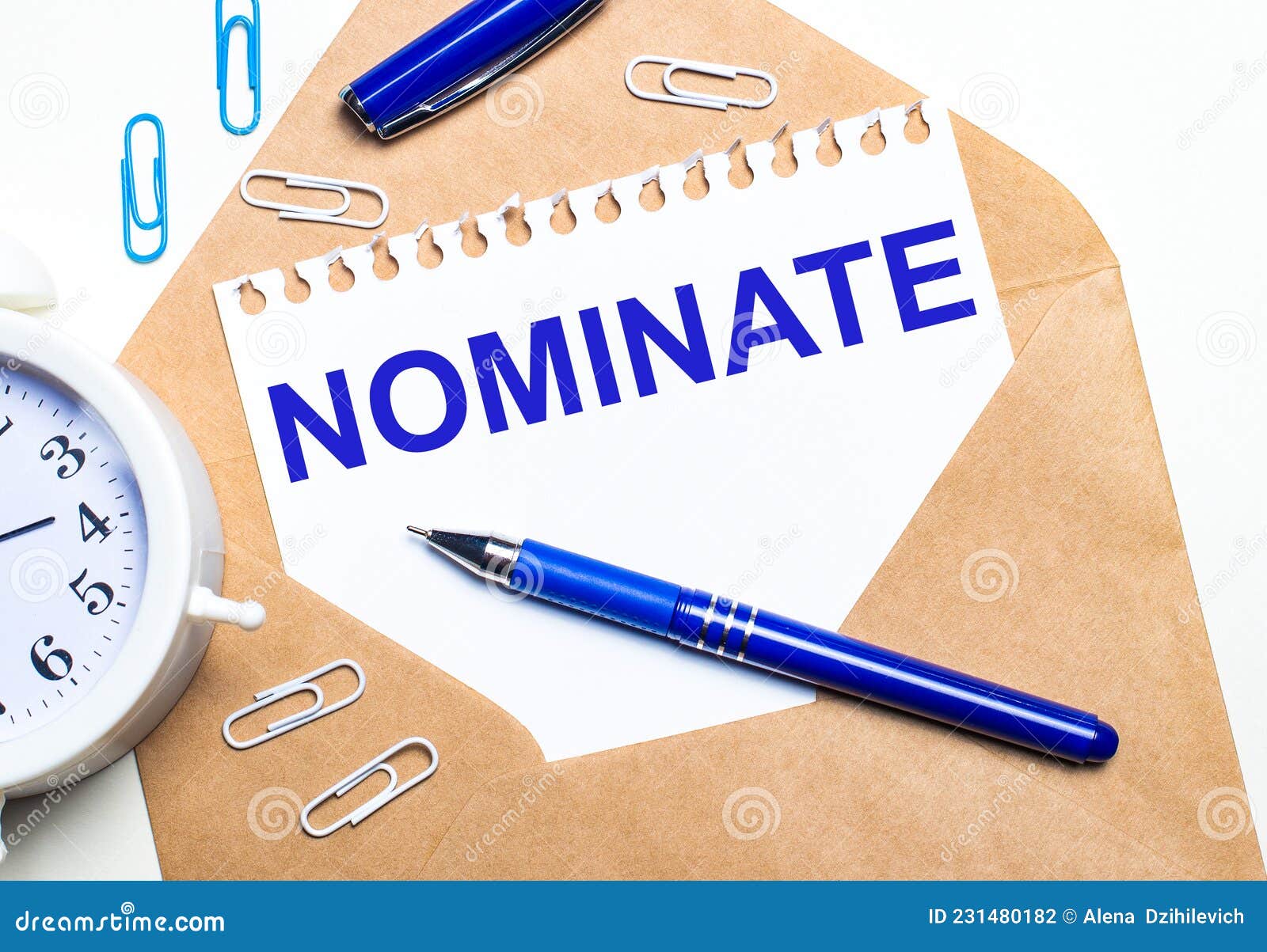 On a Light Background, a Craft Envelope, an Alarm Clock, Paper Clips, a ...