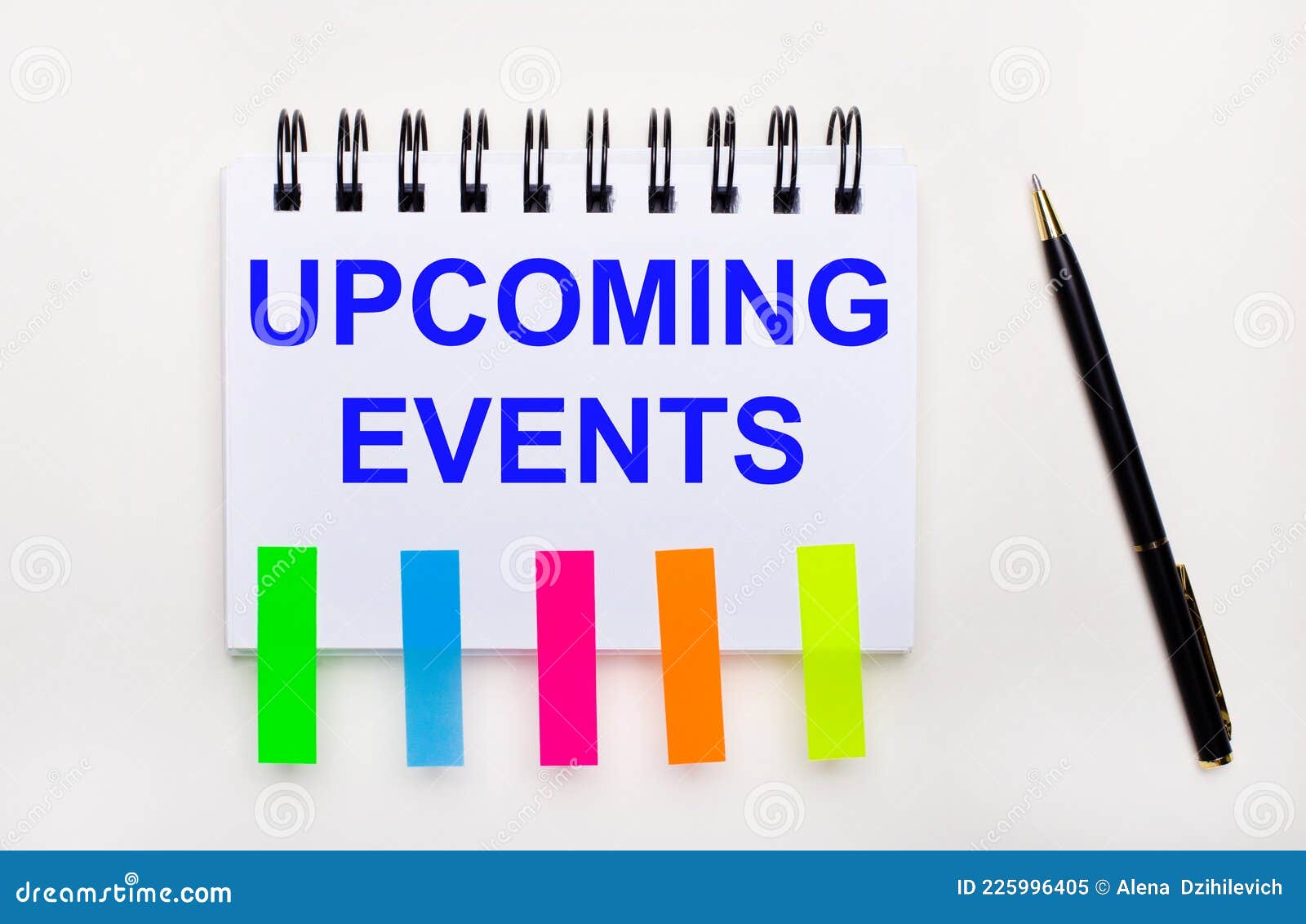 On a Light Background, a Pen, a Notebook with the Text UPCOMING EVENTS ...