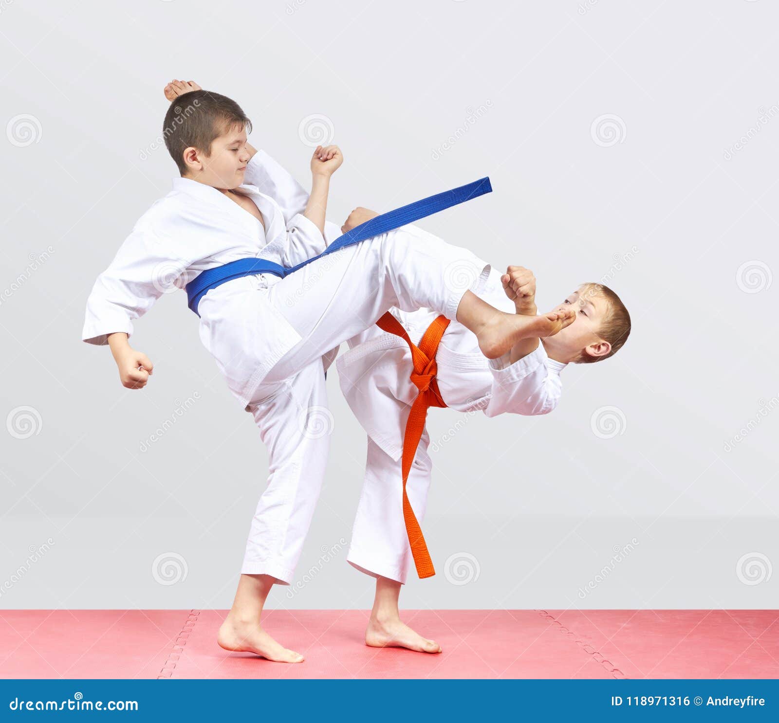 On a Light Background Two Boys are Beating Karate Kicks Stock Photo ...