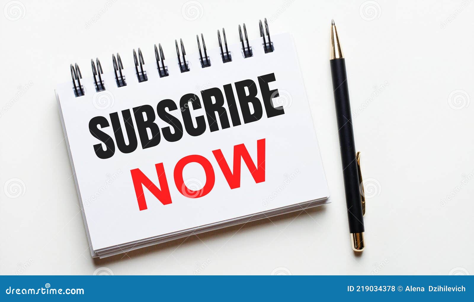On a Light Background, a White Notebook with are Words SUBSCRIBE NOW ...