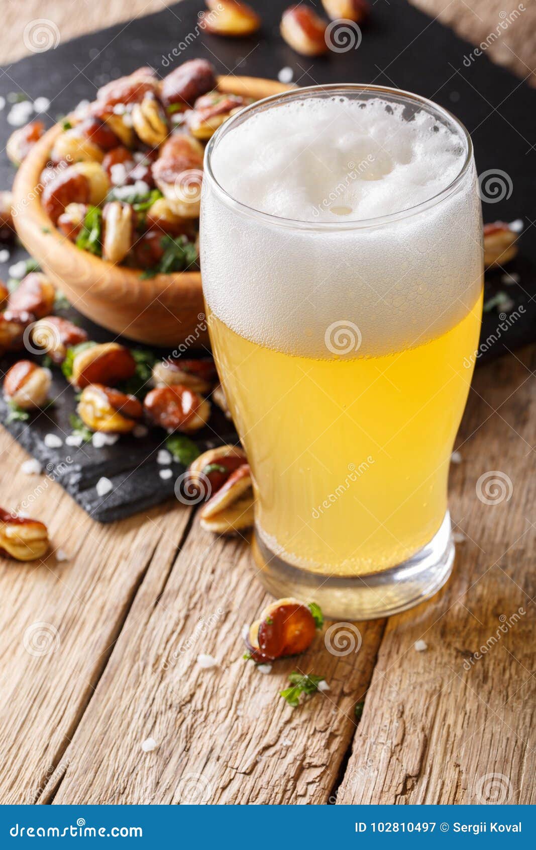 Light Beer Frothy and Fried Salted Broad Beans Close-up. Vertical Stock ...