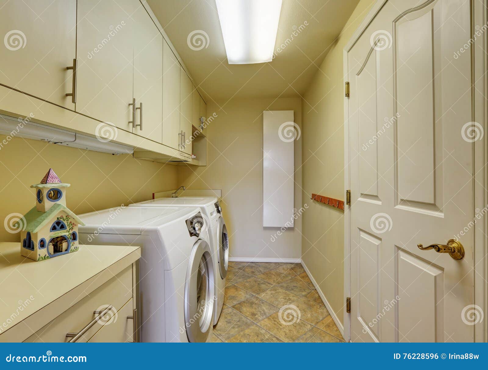 Light Beige Laundry Room with Cabinets and Tile Floor Stock Photo ...