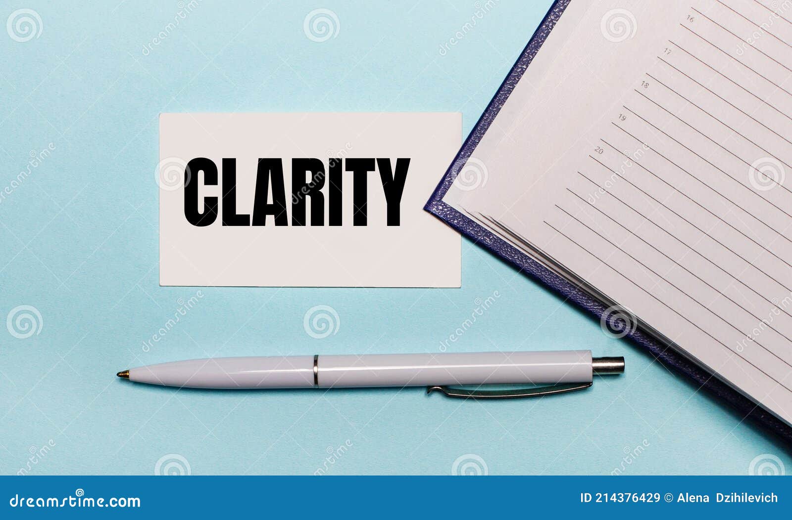 On a Light Blue Background, an Open Notebook, a White Pen and a Card ...