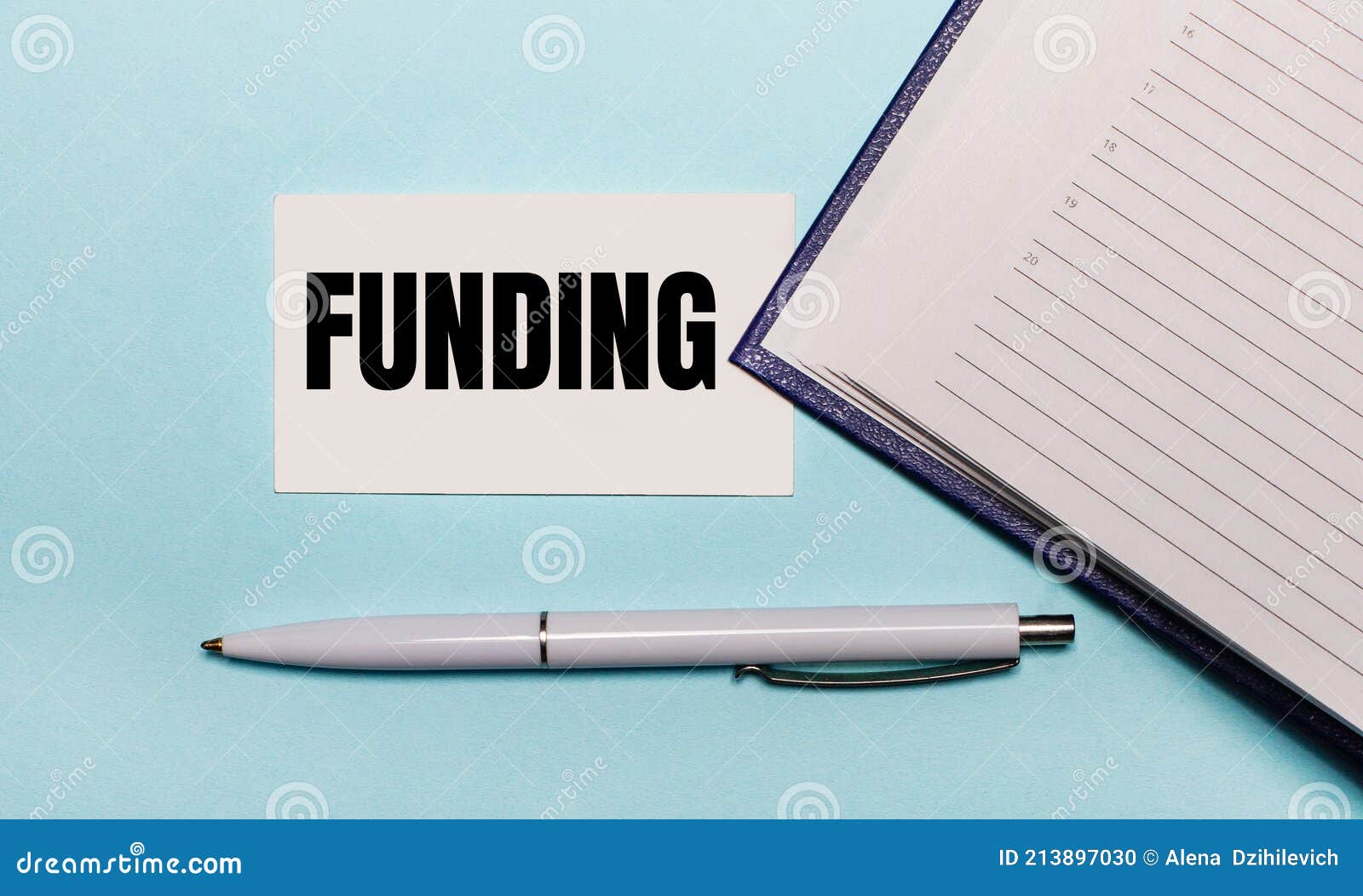 On a Light Blue Background, an Open Notebook, a White Pen and a Card ...
