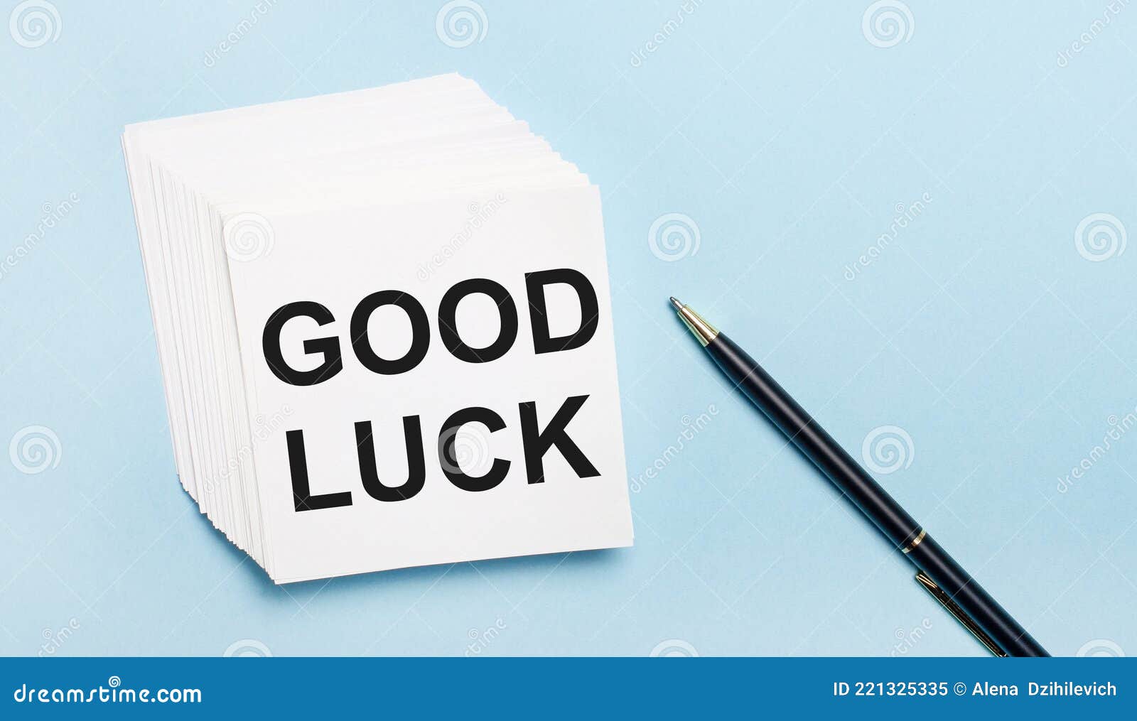 On a Light Blue Background, There is a Black Pen and a Stack of White ...